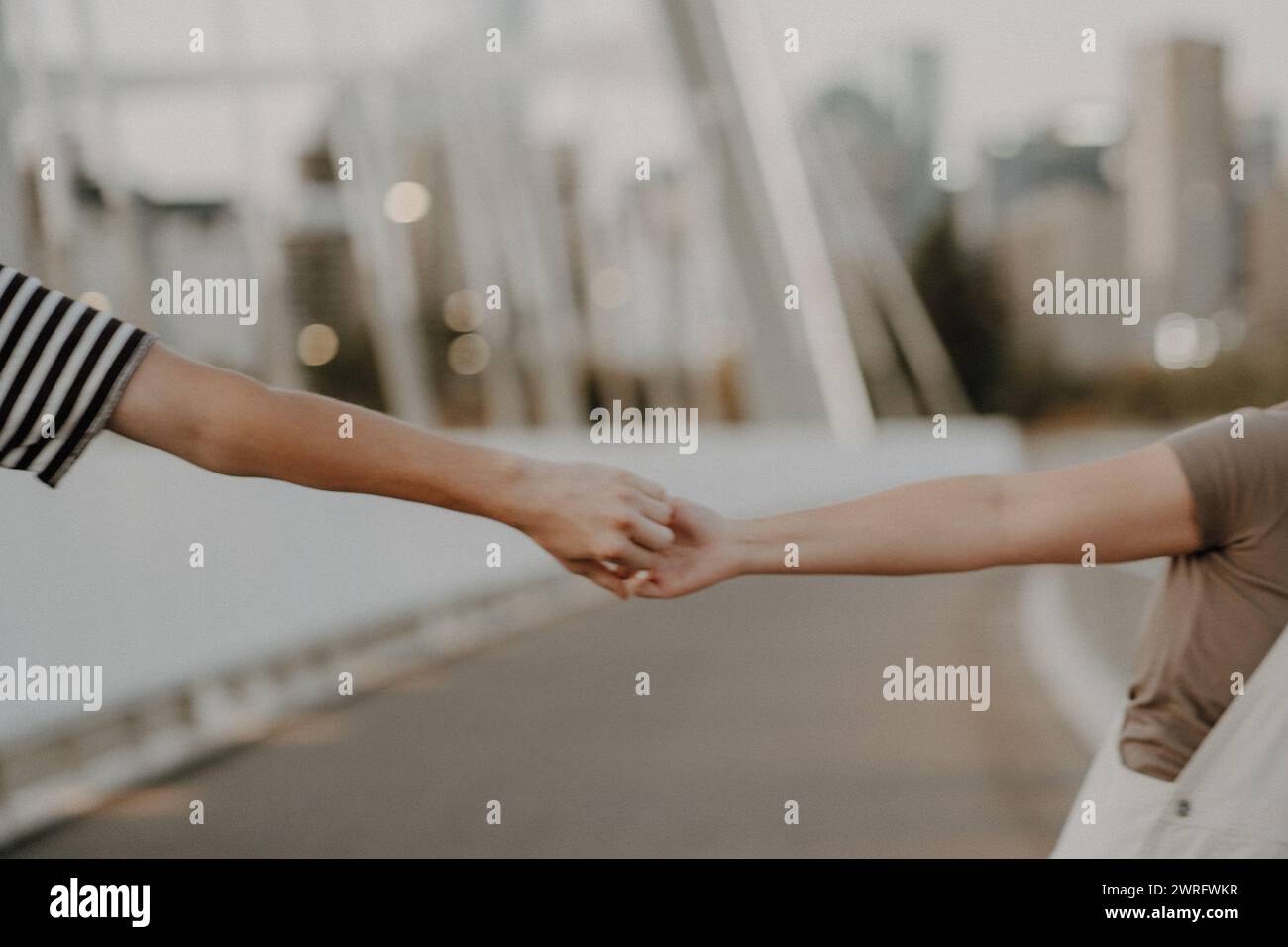 Holding hands playful pose Stock Photo - Alamy