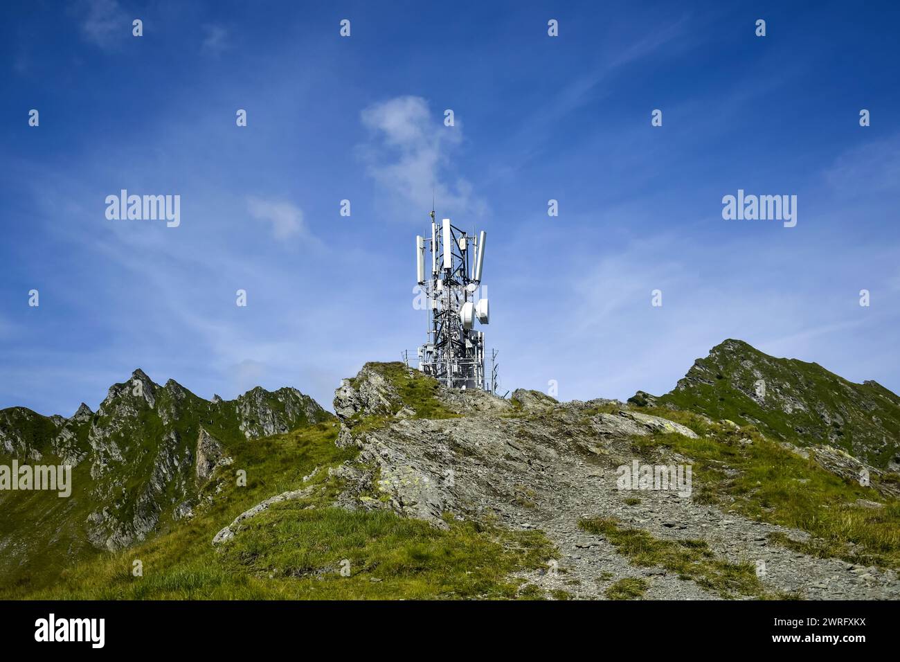 Metal tower with various telecommunication antennas on top of a ...