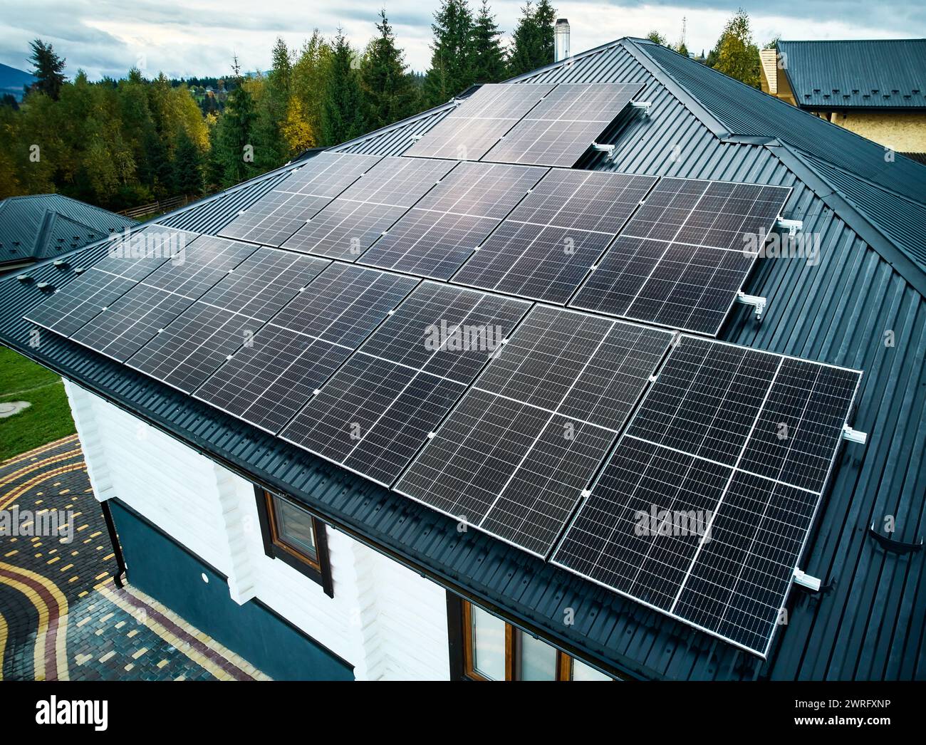 Aerial view of new modern house cottage with solar photovoltaic panel ...