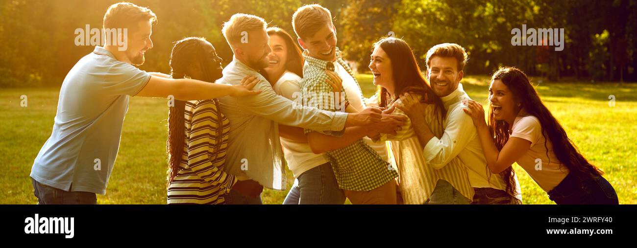 Group of happy cheerful diverse friends meeting and hugging in sunny ...