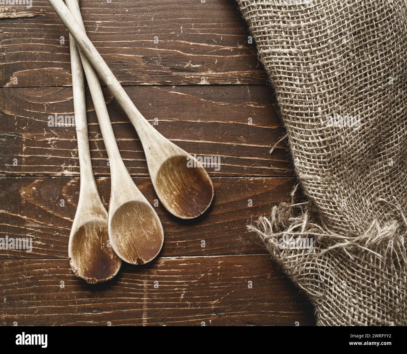 Wooden kitchen spoons and burlap on rustic wood Stock Photo - Alamy