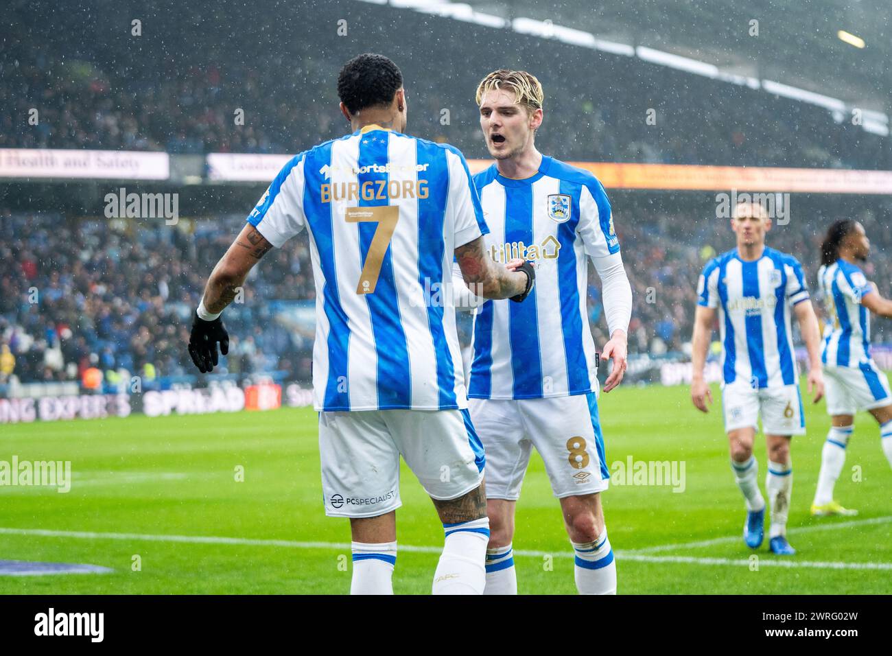 Huddersfield Town forward Delano Burgzorg (7) and Huddersfield Town ...