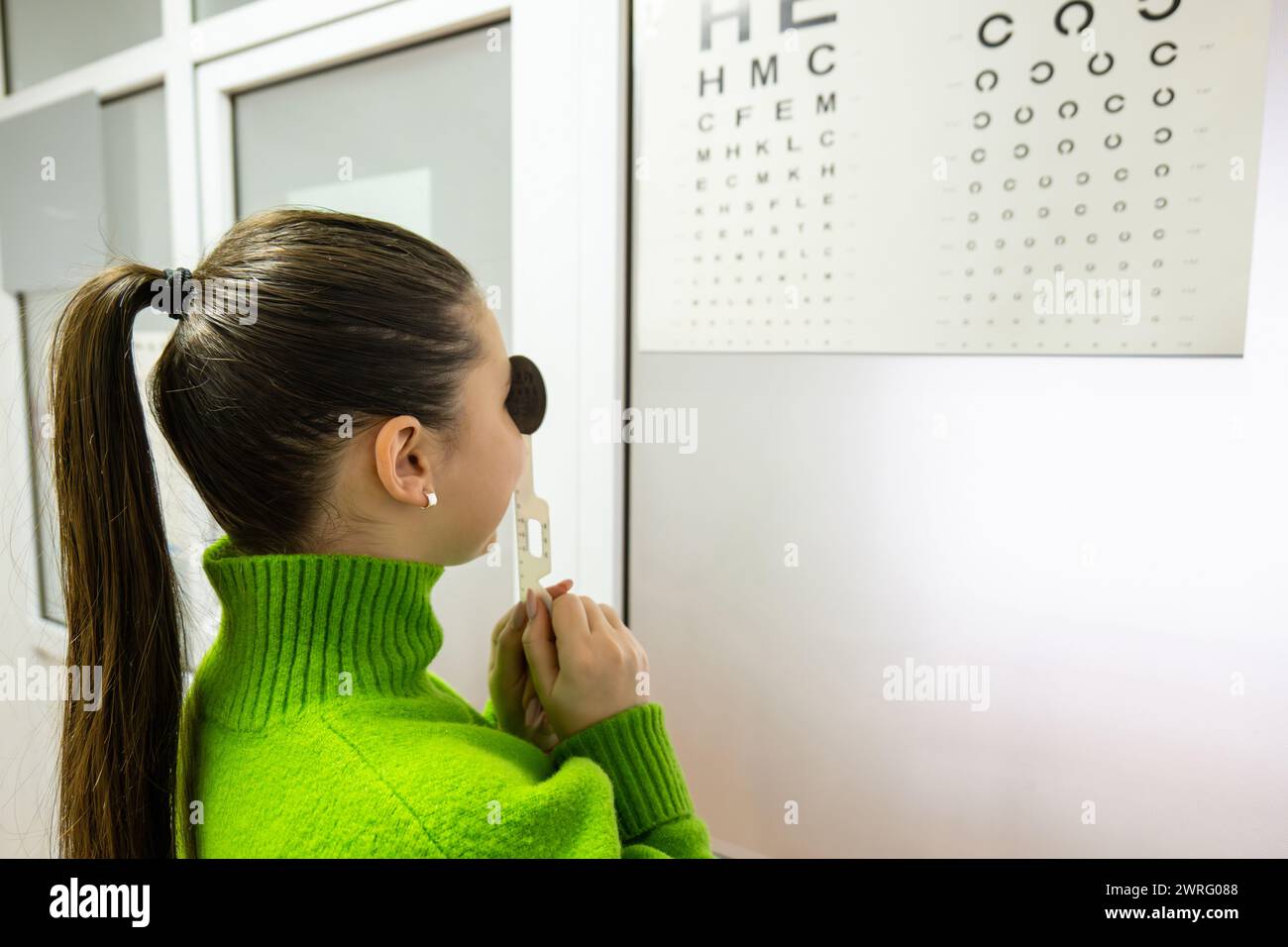 A woman with very beautiful hair surprised while looking with one eye ...