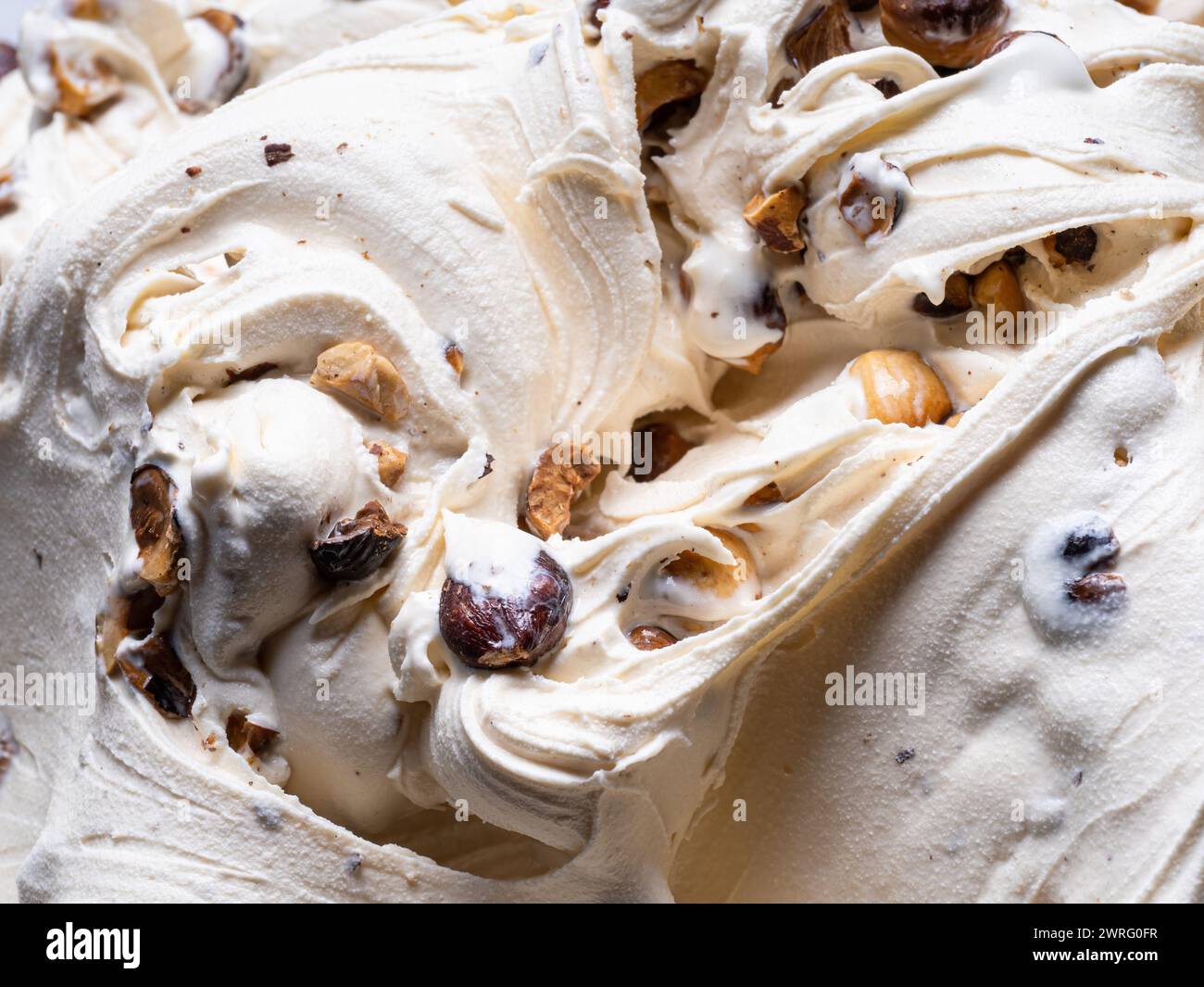 Frozen Hazelnut flavour gelato - full frame detail. Close up of a white ...
