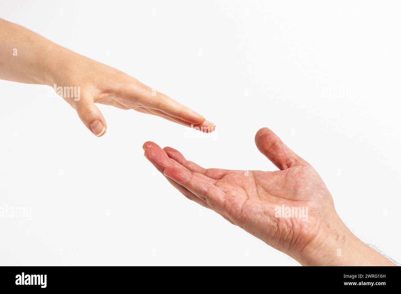 Women's hand goes to the man's hand on white background Stock Photo - Alamy