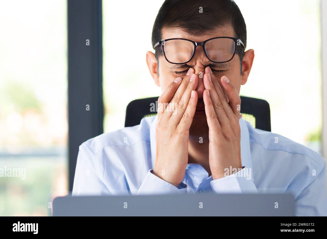 Office worker complaining suffering eyestrain at work Stock Photo - Alamy