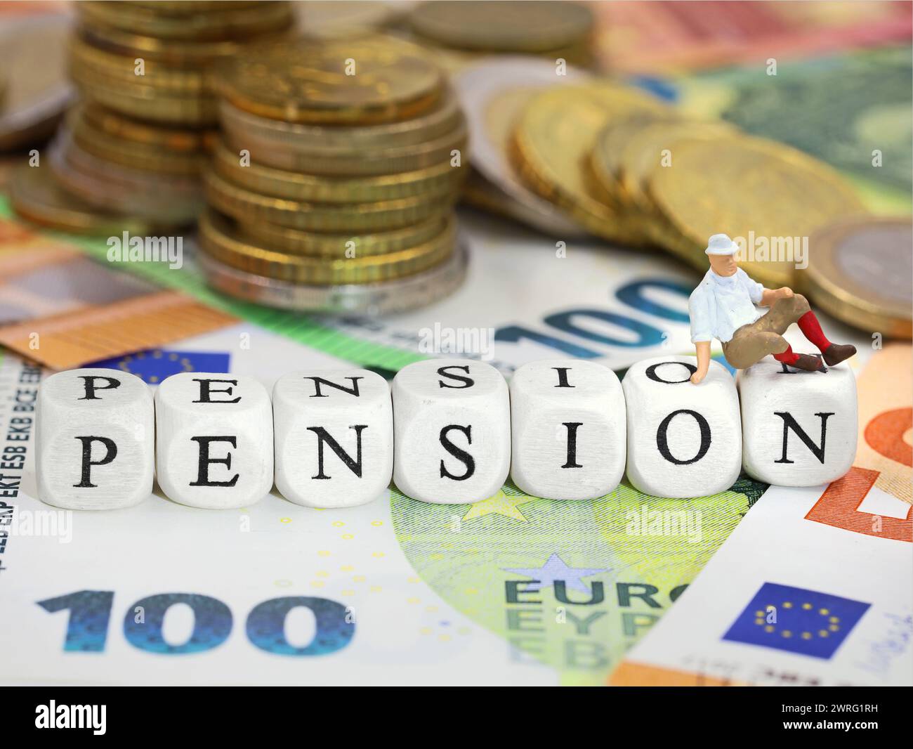 wooden letter cubes form the word PENSION on euro money background with ...