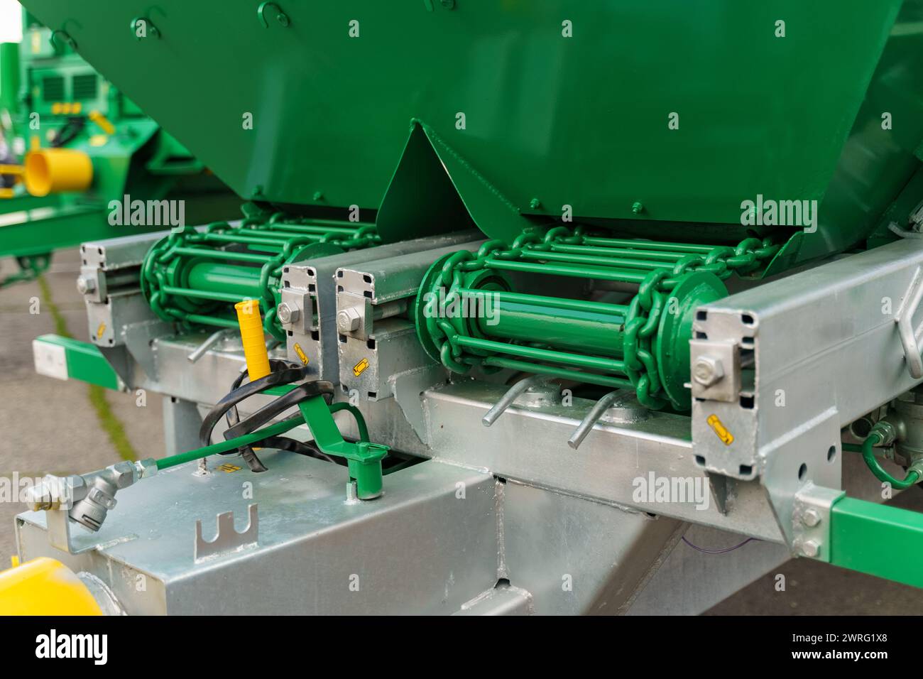 Green agricultural machine - mineral fertilizer distributor, standing ...