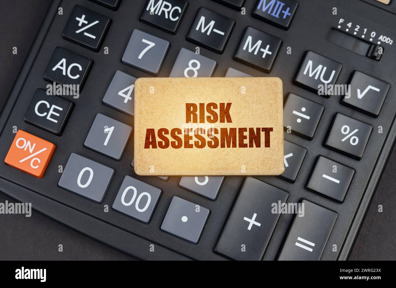 Financial concept. There is a sign on the calculator that says - Risk ...