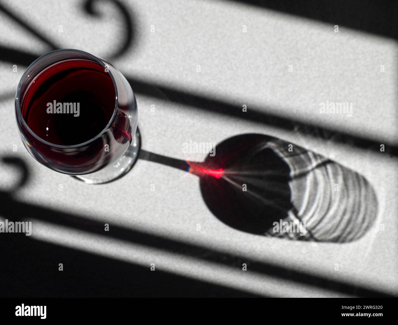 Shadow and reflection of red wine glass Stock Photo - Alamy