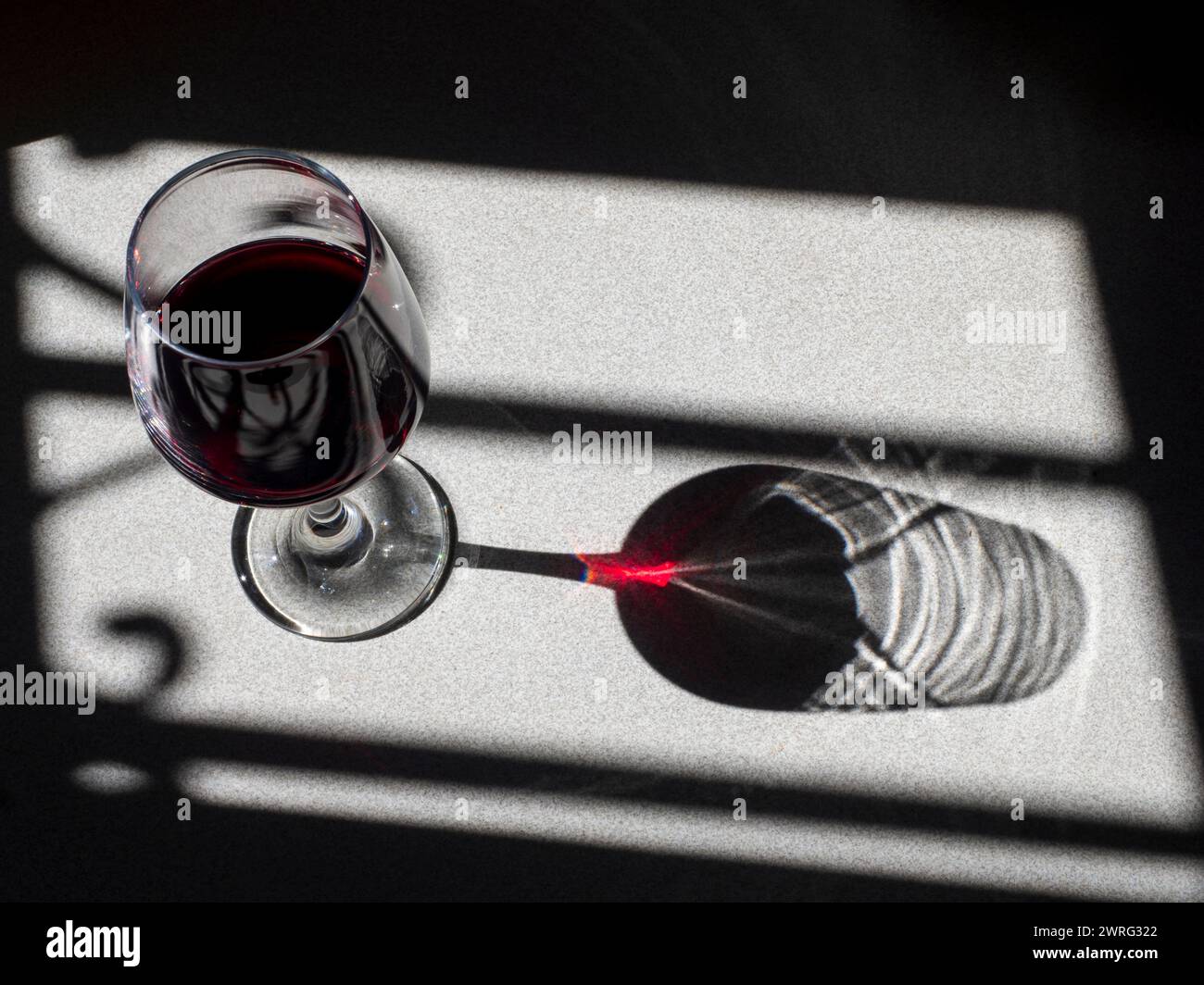 Shadow and reflection of red wine glass Stock Photo - Alamy