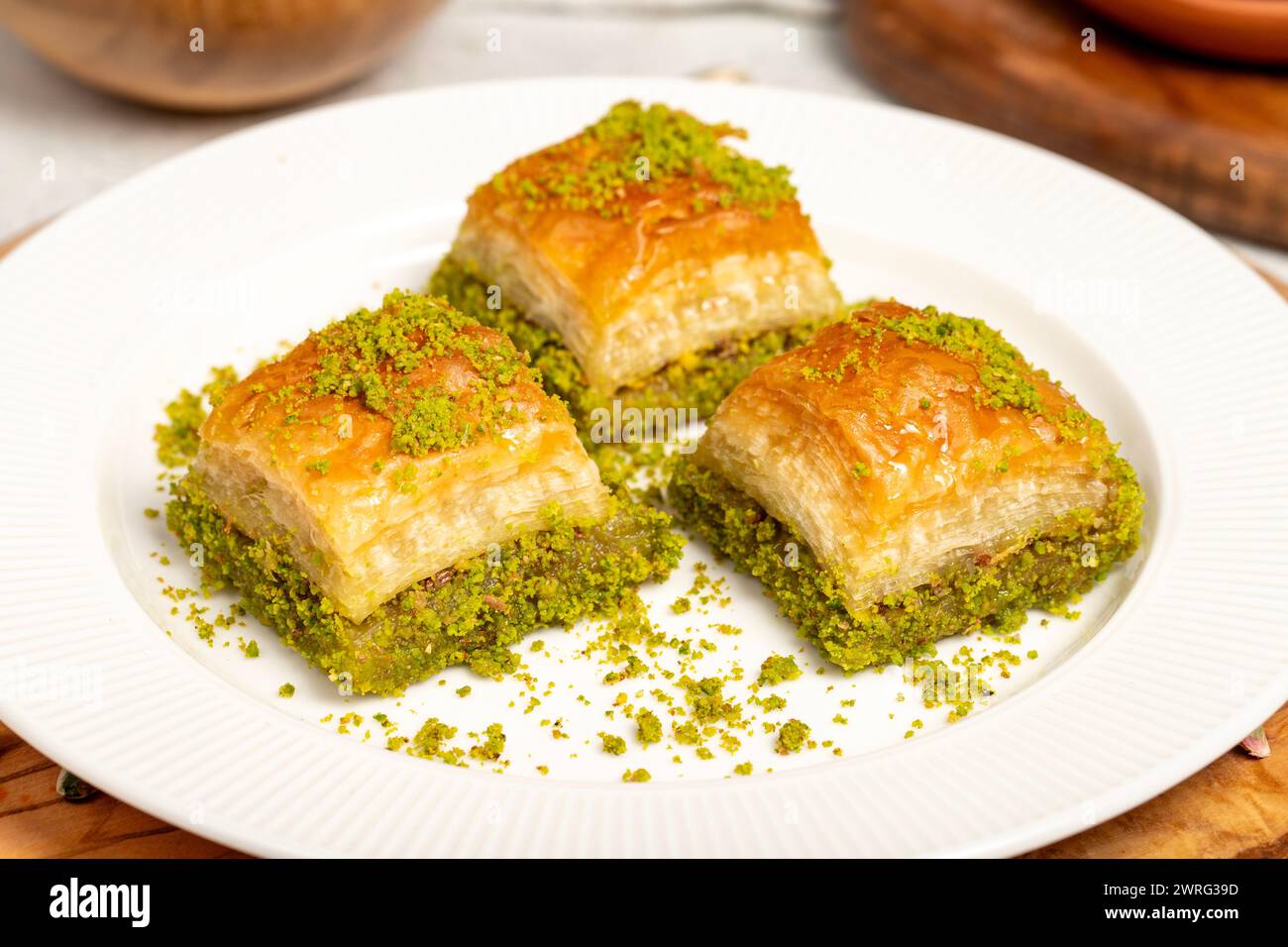 Baklava with pistachios on a wooden background. Turkish cuisine ...