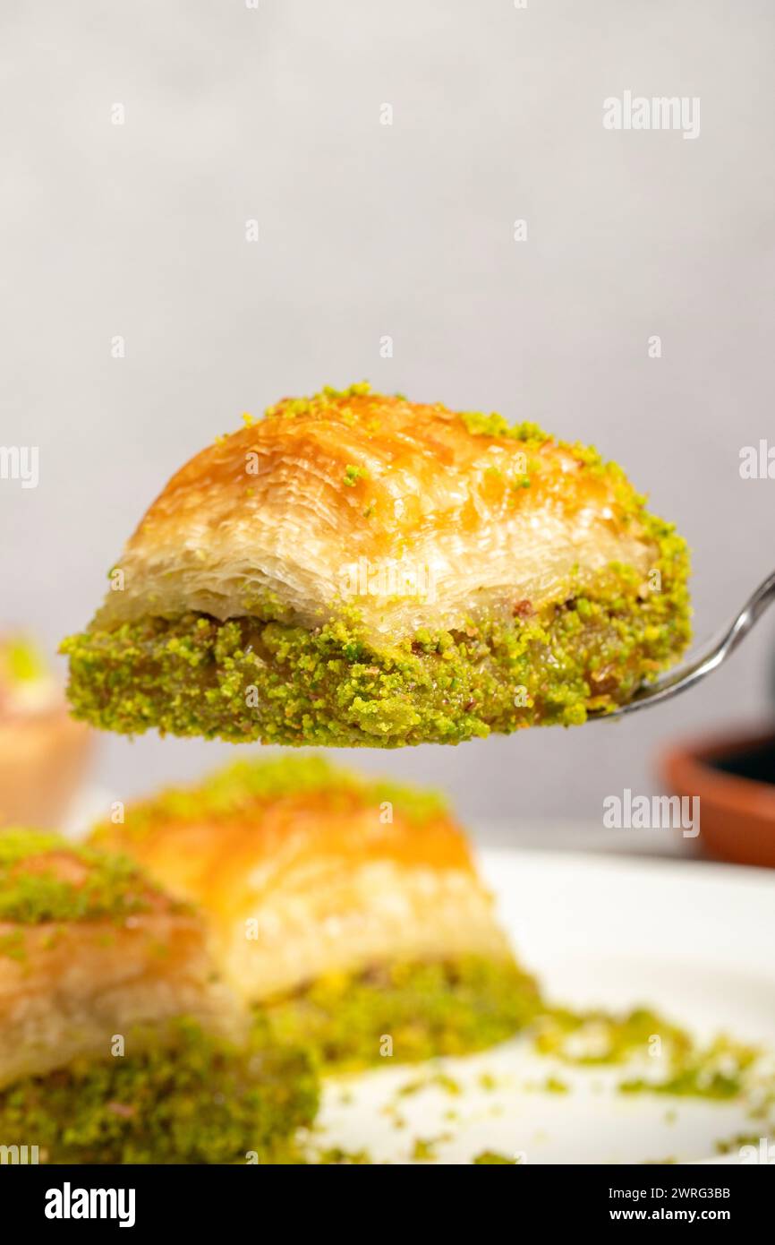 Baklava with pistachios on a wooden background. Turkish cuisine ...