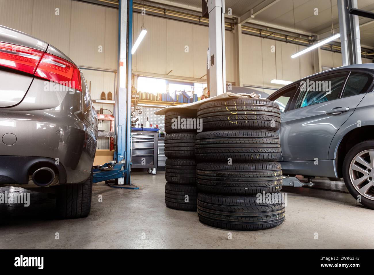 Car wheel repair with two auto lift back view. Seasonal winter tyre ...