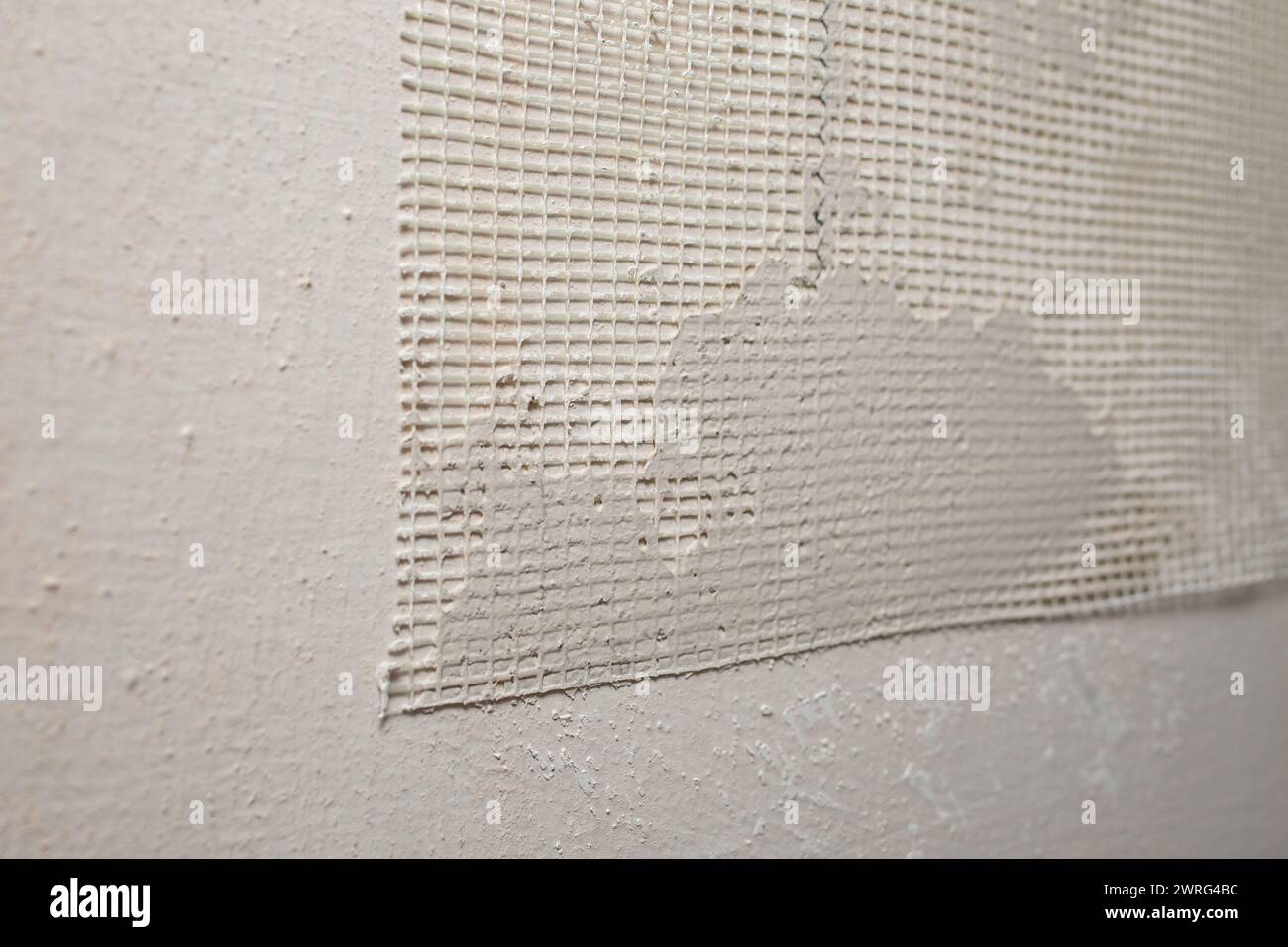 Fixing a wall with a mesh, abstract soft focus Stock Photo - Alamy
