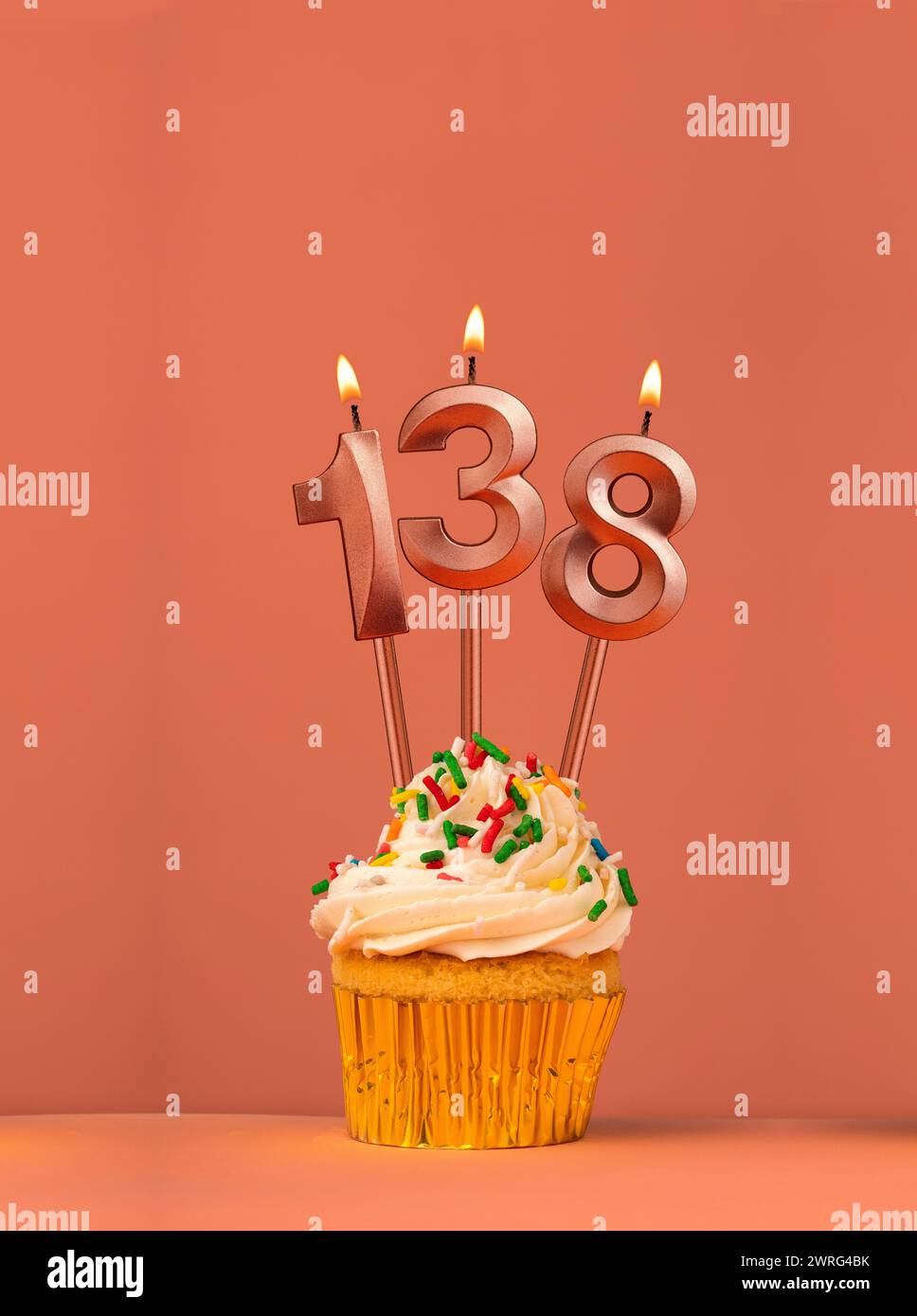 Birthday cupcake with candle number 138 - Coral fusion background Stock ...