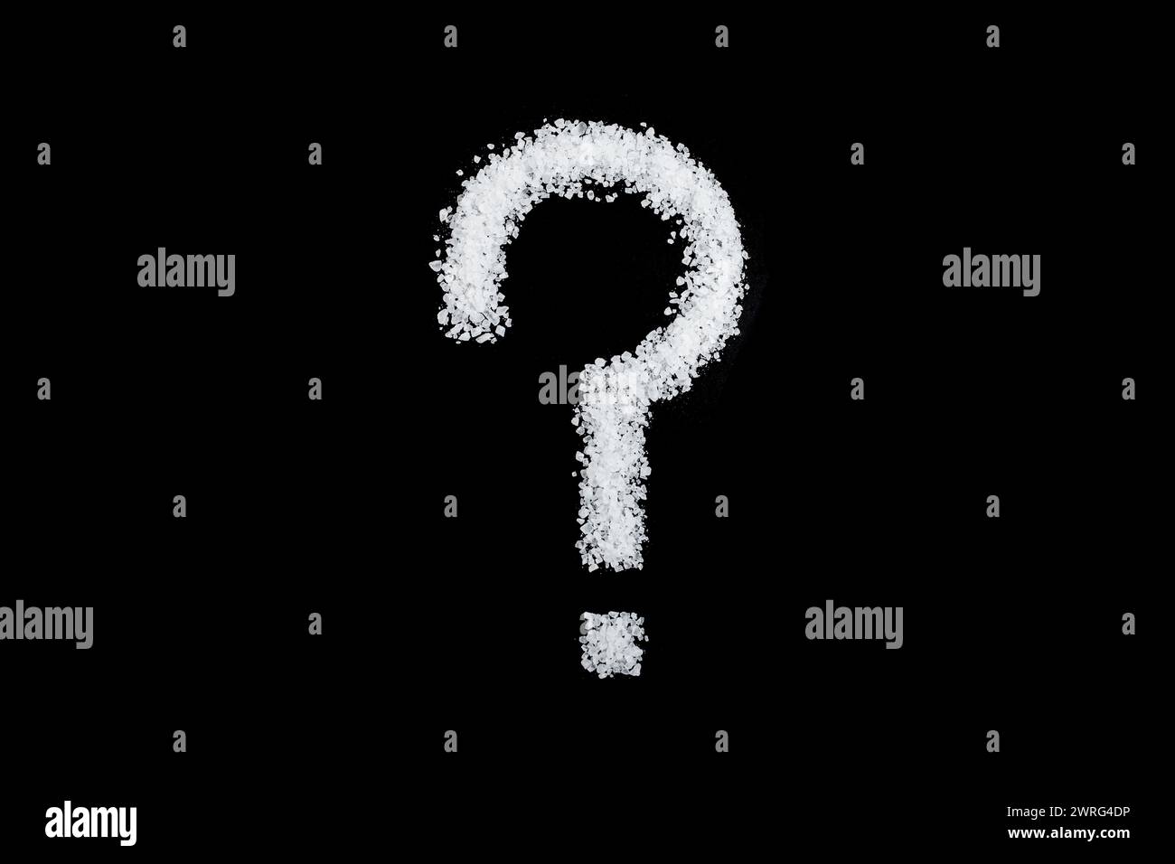Question mark symbol made with rock salt grain, on black background ...