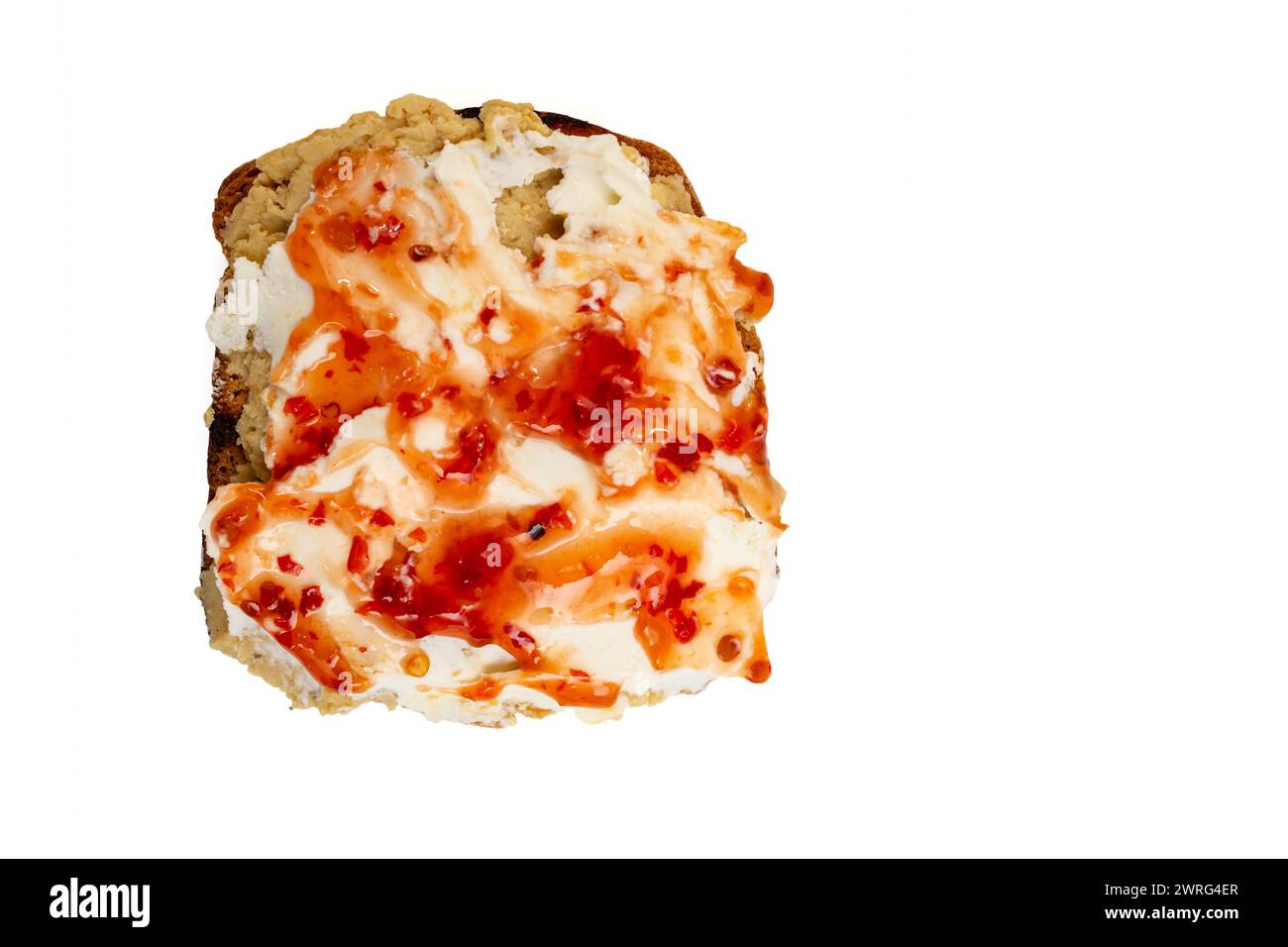 Humus paste with cheese and chili sauce on a toasted bread slice ...