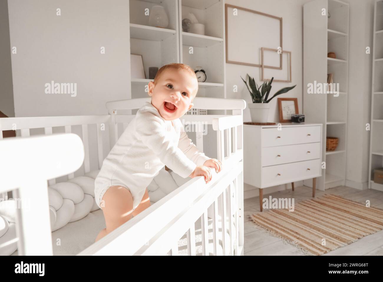 Adorable little baby in crib at home Stock Photo - Alamy