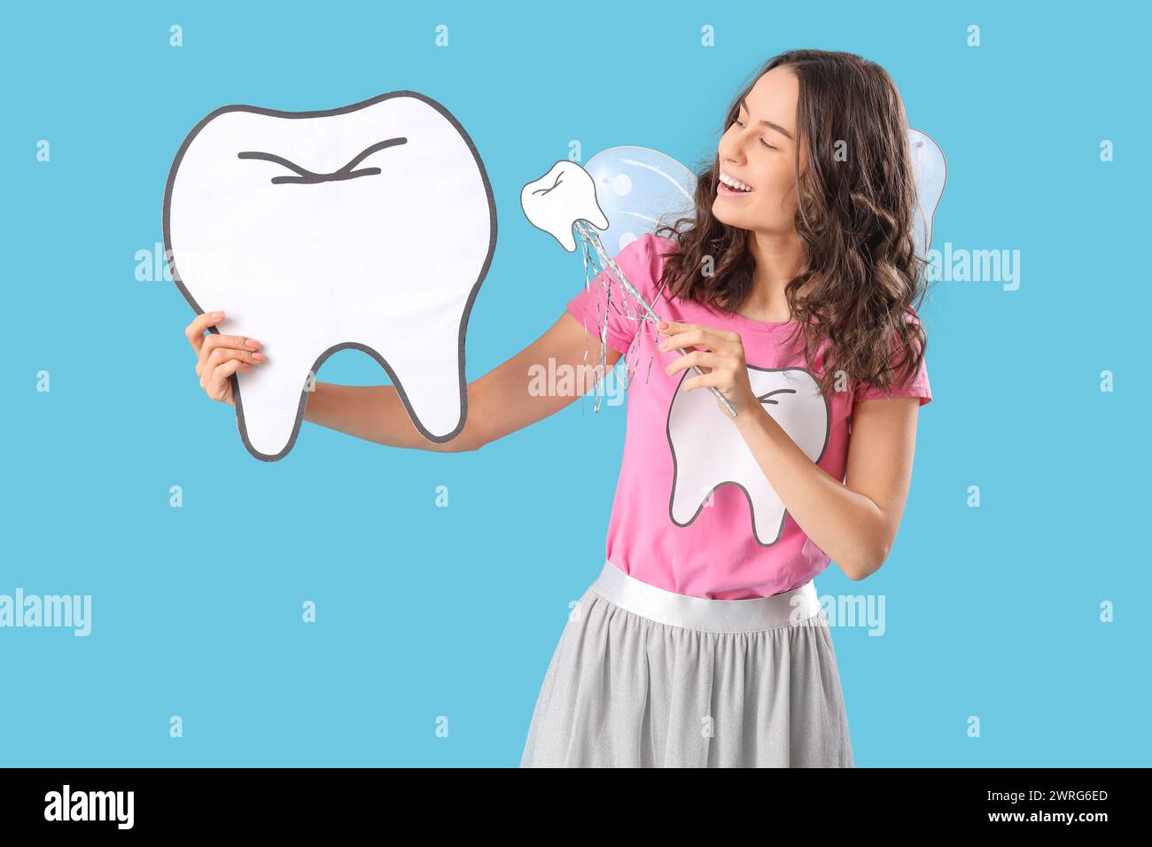 Tooth Fairy with wand and paper figure on blue background Stock Photo ...