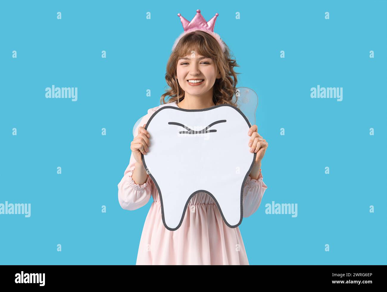 Tooth Fairy with paper figure on blue background Stock Photo - Alamy