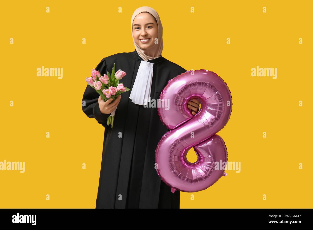Muslim female judge with balloon in shape of figure 8 and pink tulips ...