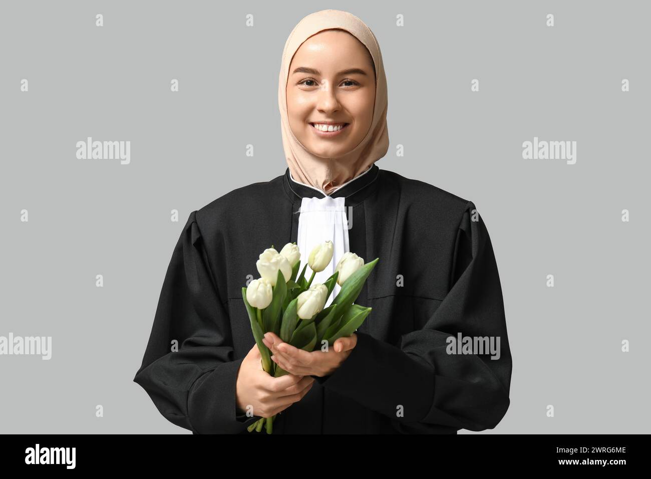 Muslim female judge with tulips on white background. Women's Day ...