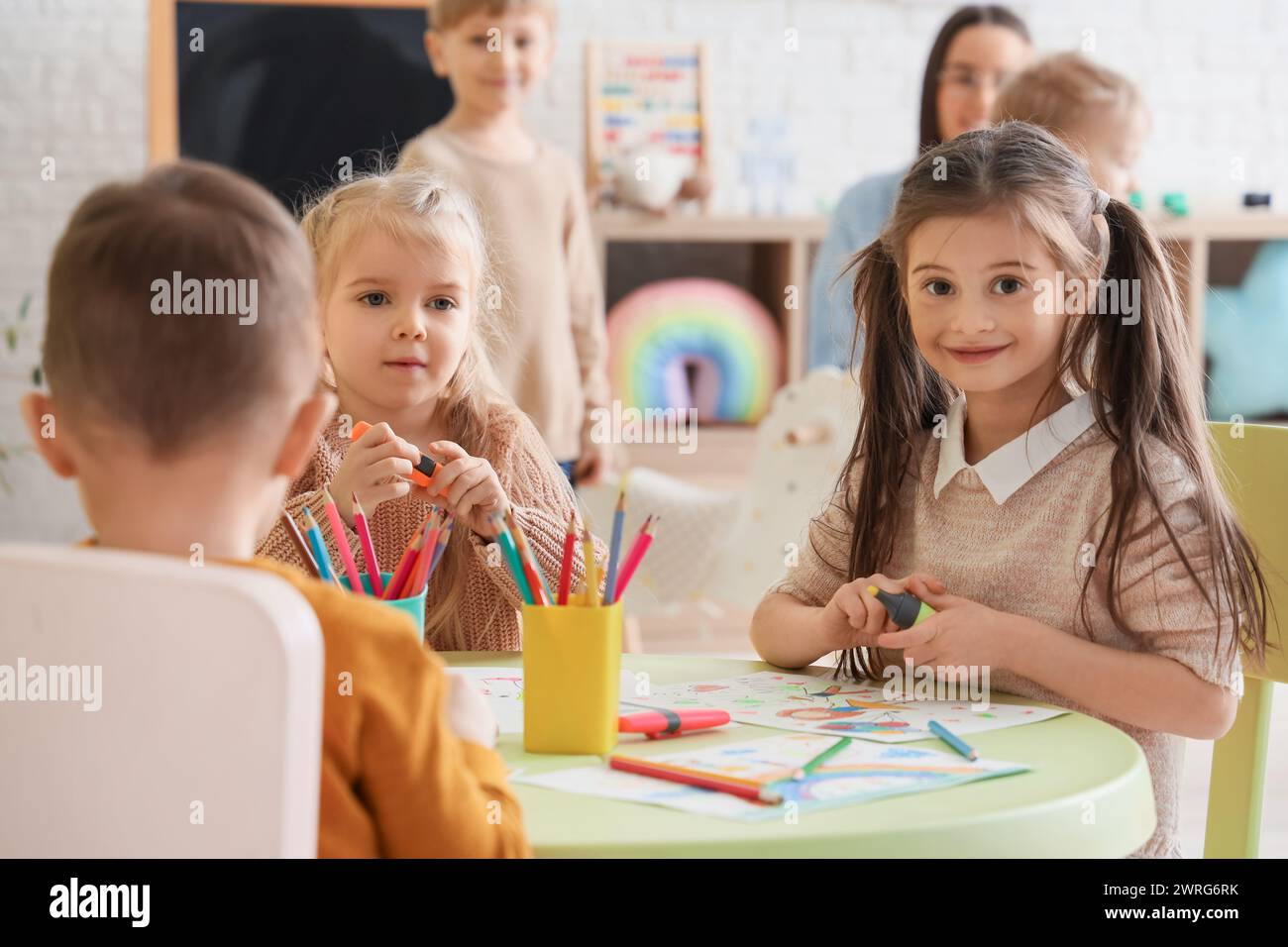Little girls drawing at table in kindergarten Stock Photo - Alamy