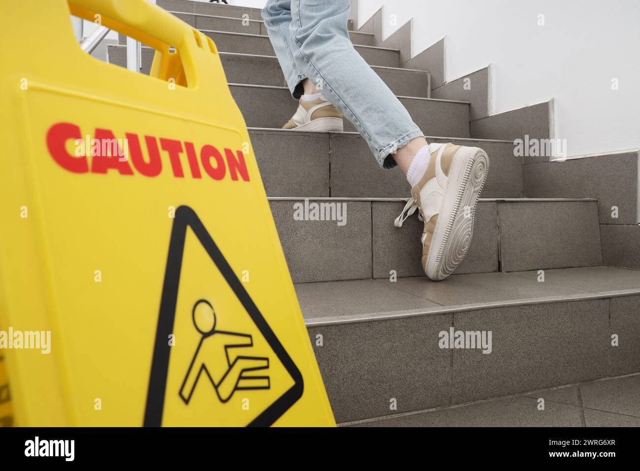 Young woman falling down on wet steps in stairway, closeup. Trauma ...