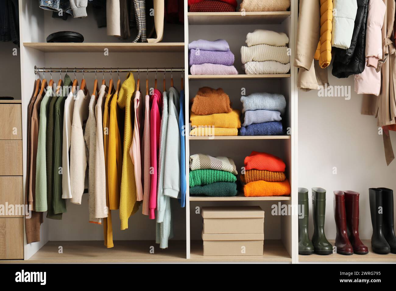 Rack with stylish female autumn clothes in modern wardrobe Stock Photo ...