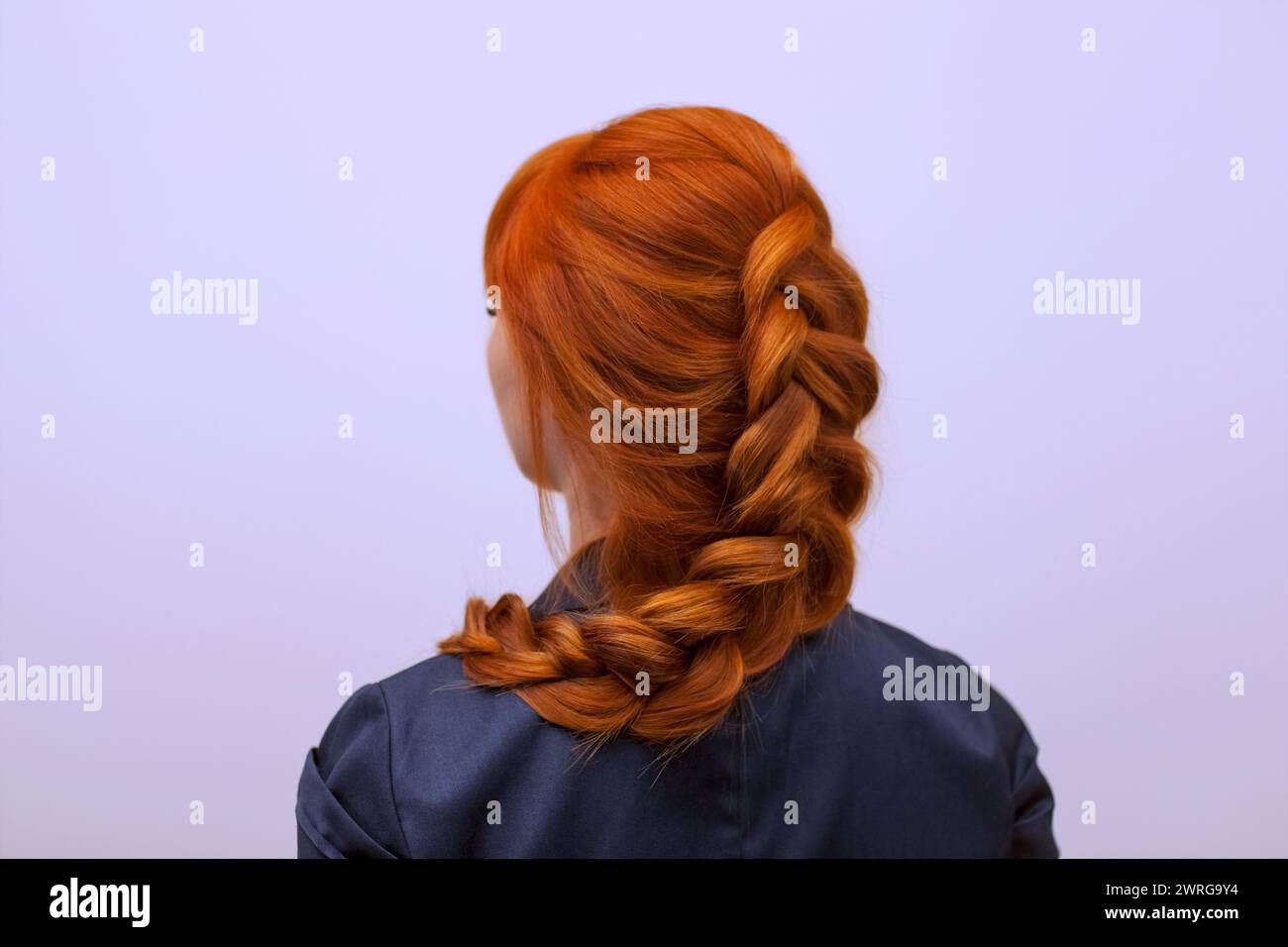 Beautiful girl with long red hair, braided with a French braid, in a ...