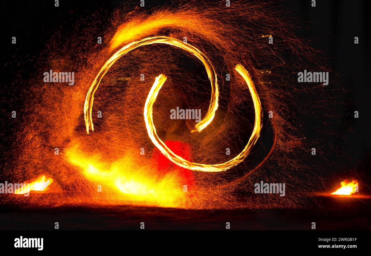 Man entertains the audience with the help of fire, carrying fire ...