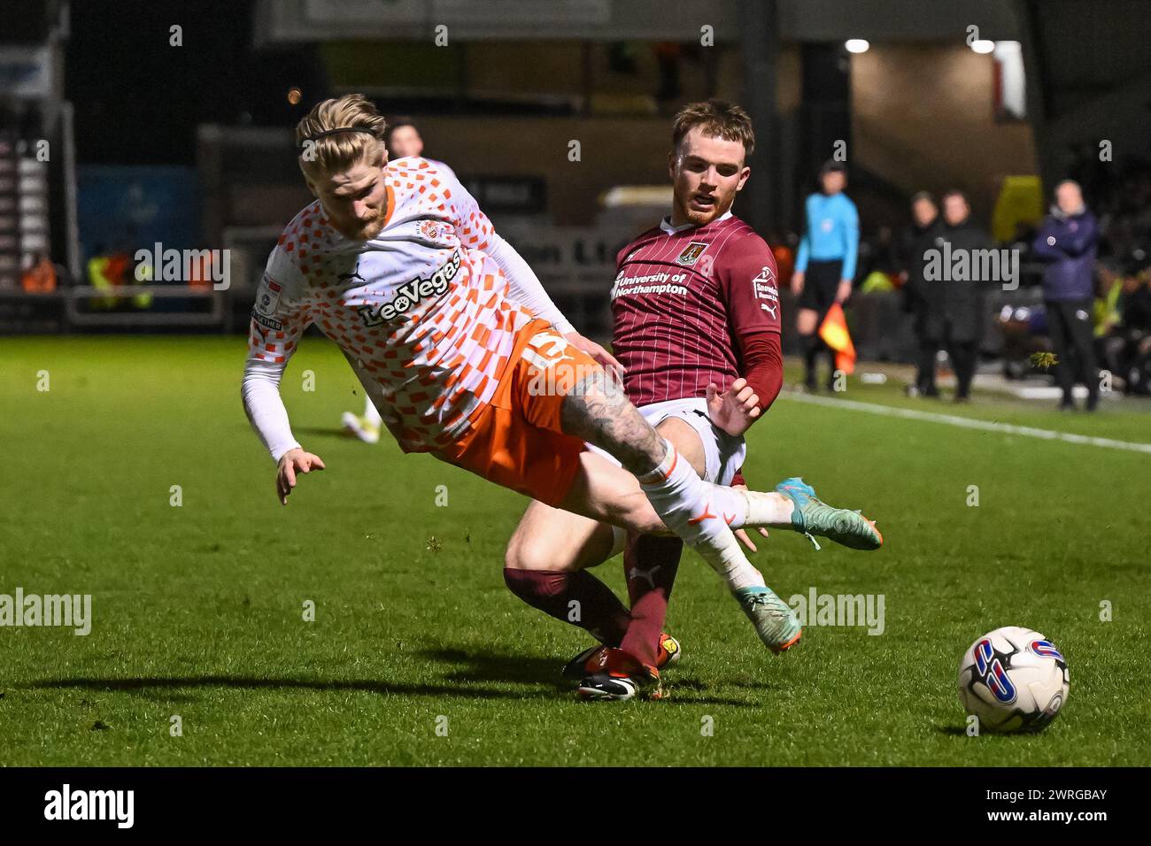 Hayden Coulson of Blackpool is tackled by Marc Leonard of Northampton ...