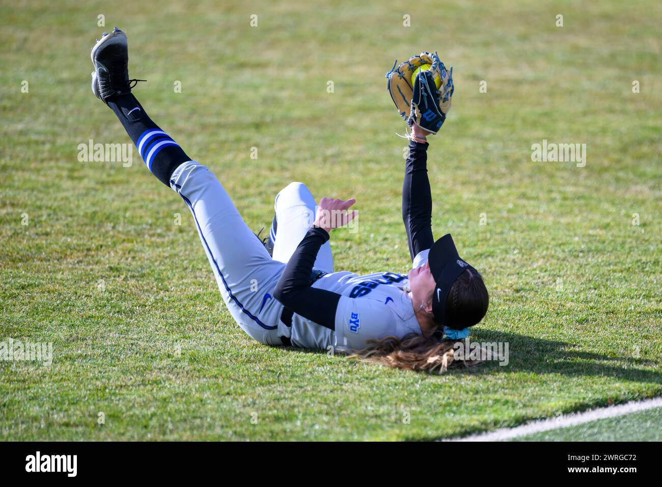 BYU outfielder Jaelynn Lambert (11) makes a sliding catch for the out ...