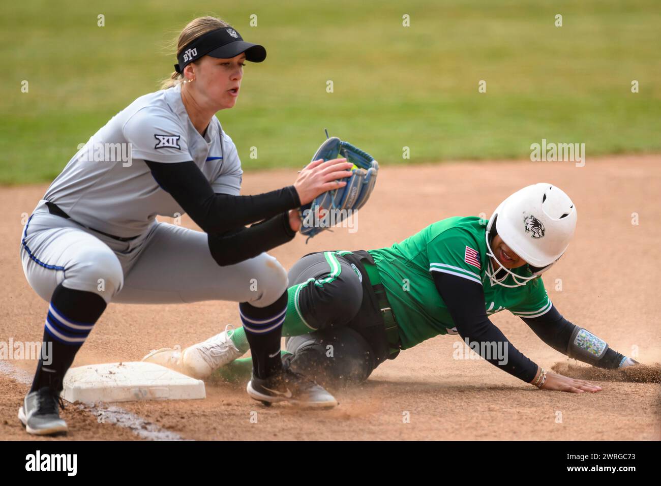 Utah Valley outfielder Angelique Mann (right) slides into third base ...