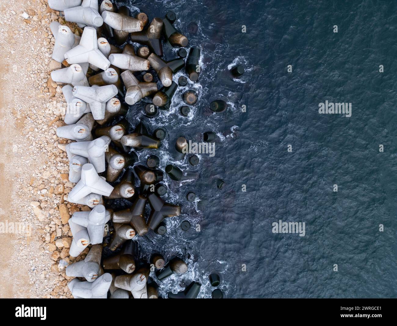 Rows of Concrete Blocks Along Beach Stock Photo - Alamy