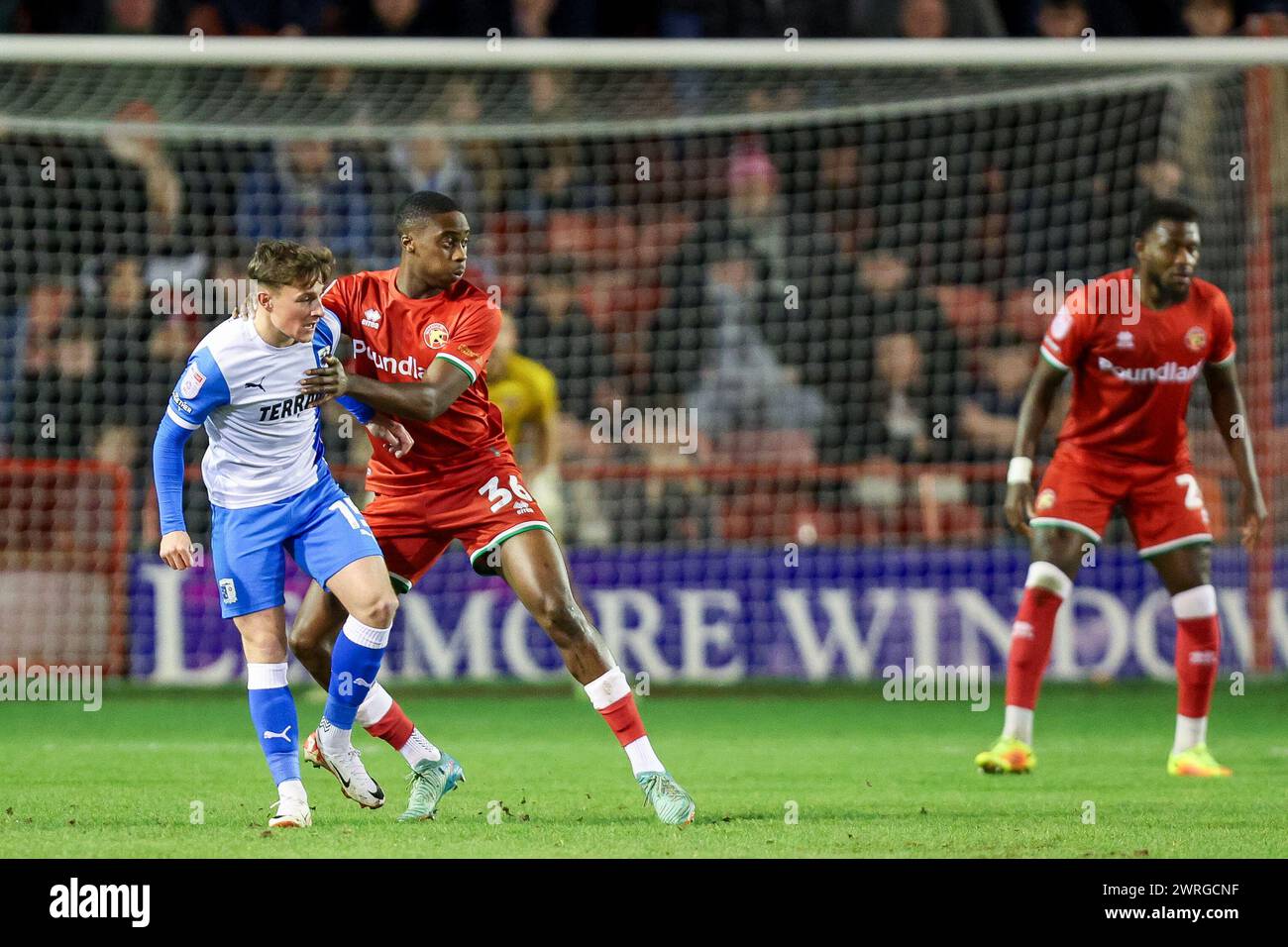 Walsall, UK. 12th Mar, 2024. Barrow's Robbie Gotts & Walsall's Emmanuel ...