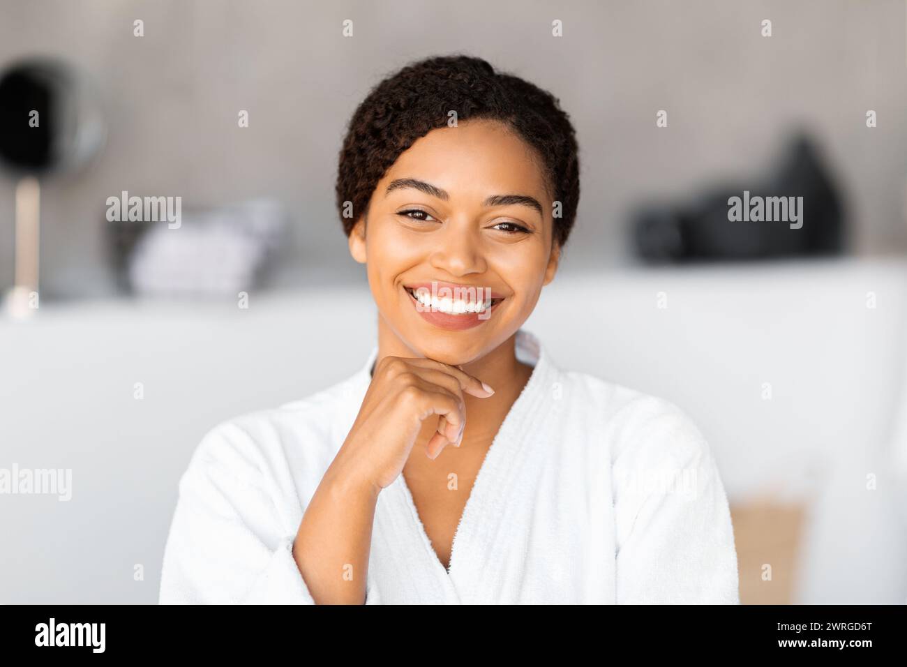 Radiant young black woman with beautiful skin smiling at camera Stock ...