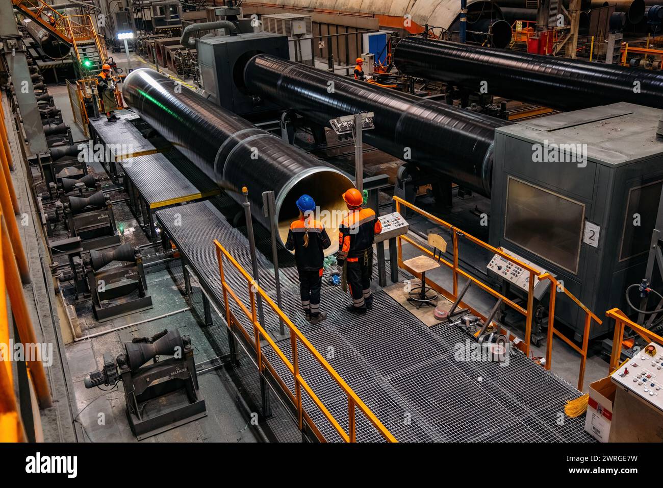 Engineers inspecting large manufactured steel pipes Stock Photo - Alamy