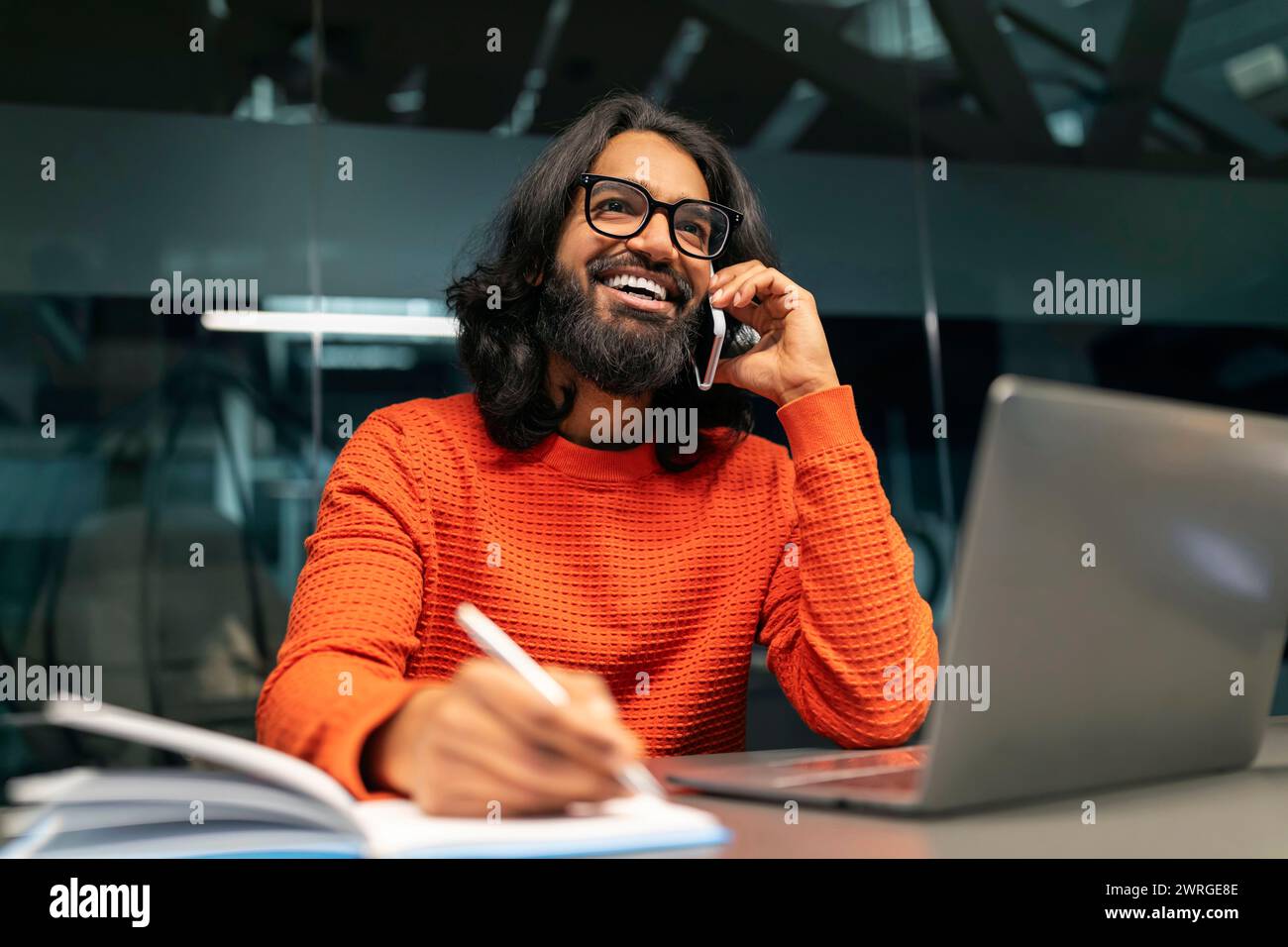 Excited millennial eastern businessman have phone conversation with ...