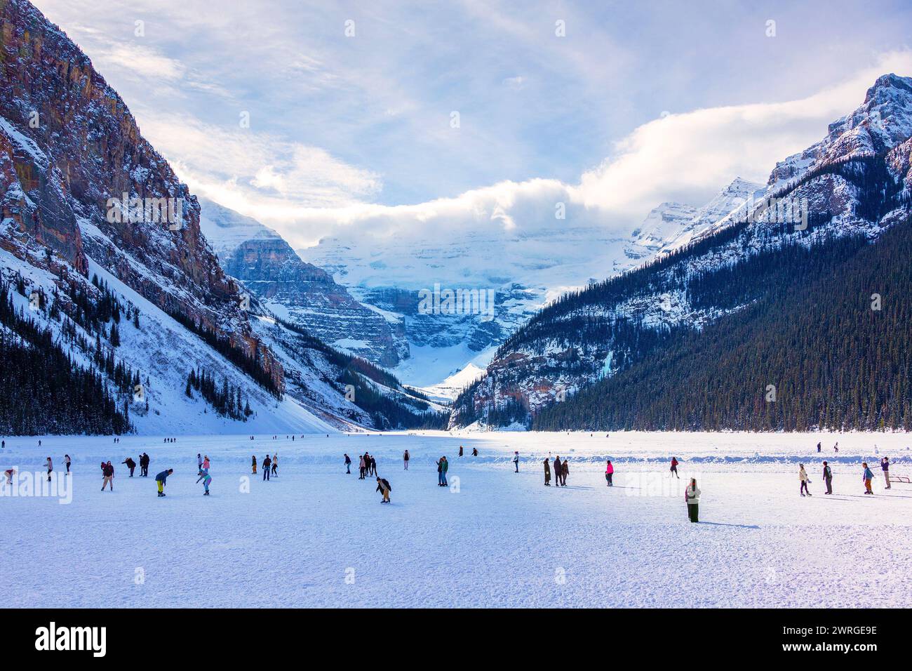 Unidentifiable visitors skating on frozen Lake Louise in the winter ...