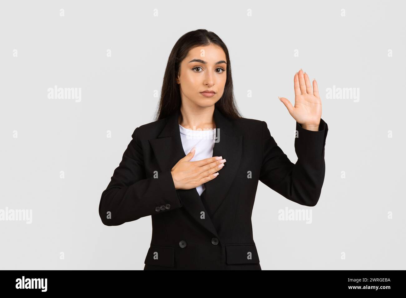 Serious young businesswoman taking oath Stock Photo - Alamy