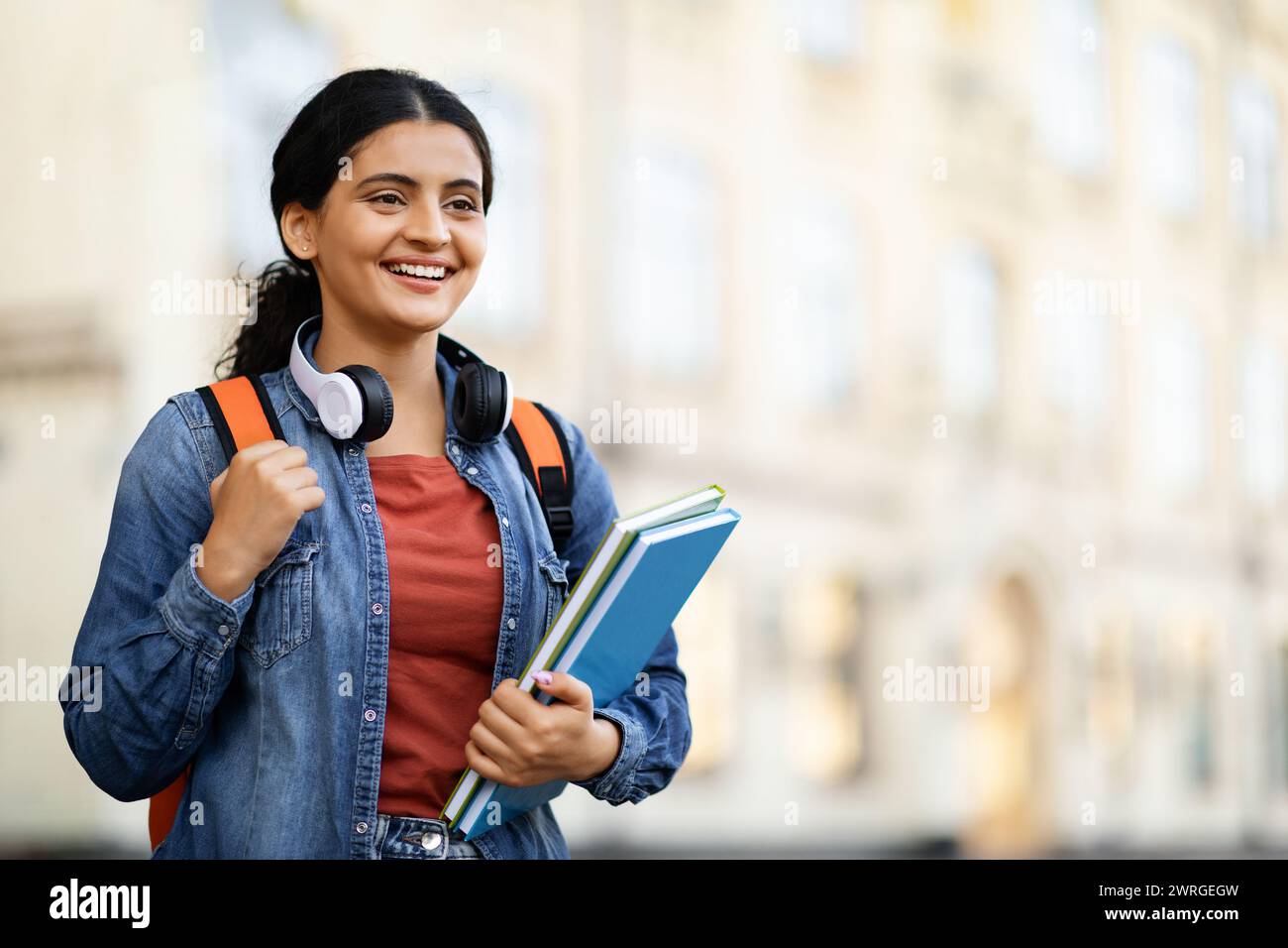 Positive young eastern lady student posing at university campus Stock ...