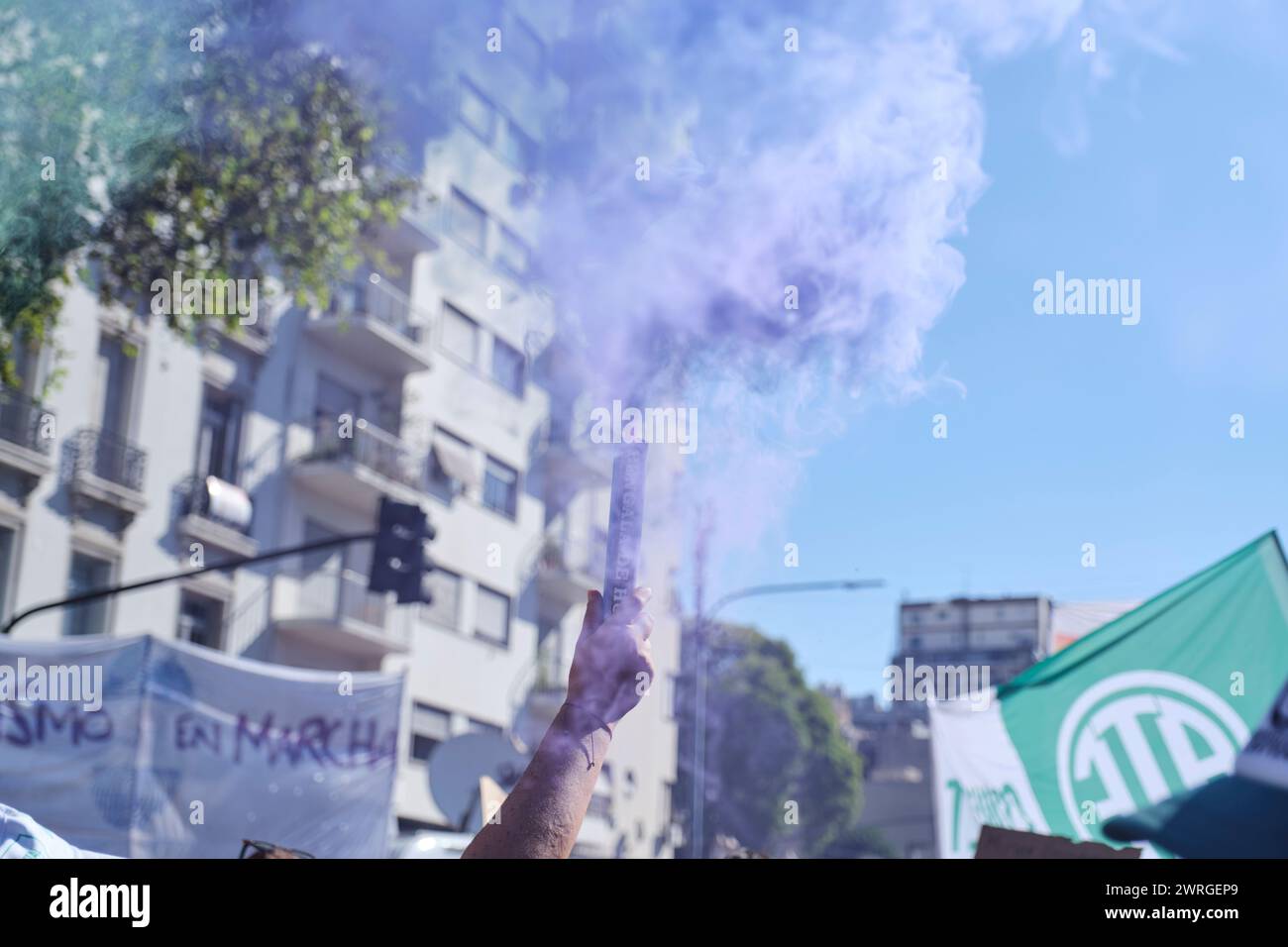 Buenos Aires, Argentina; March 8, 2024: hand raising a purple smoke ...