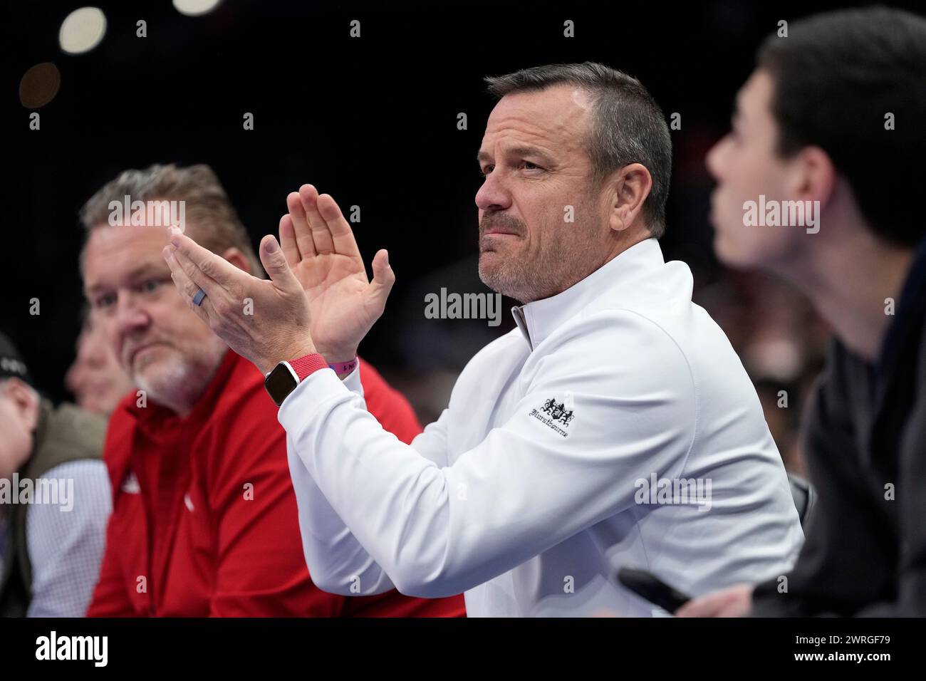 Louisville women's basketball coach Jeff Walz, applauds as he watches ...