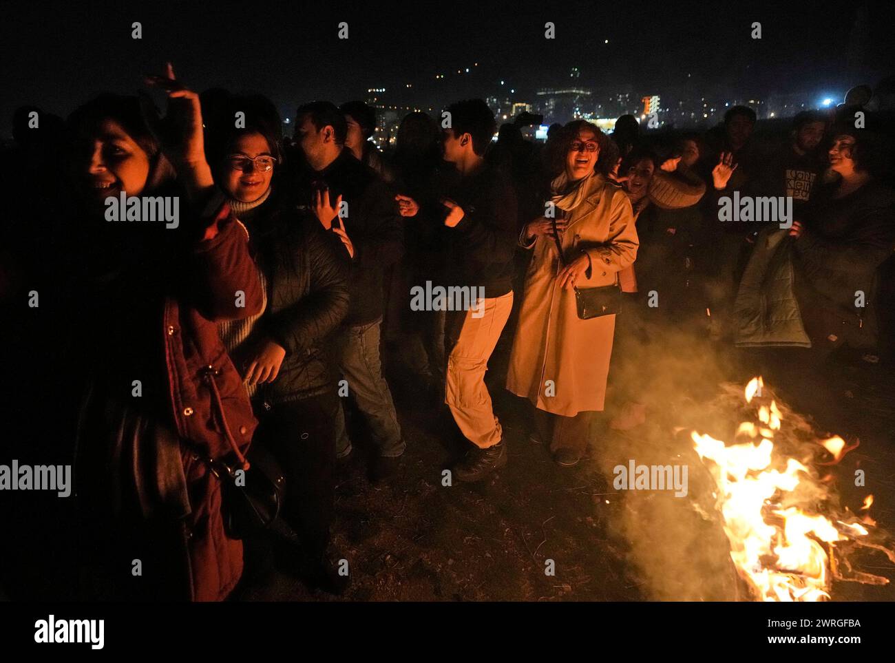 Joyful people circle around a bonfire as they celebrate Chaharshanbe ...