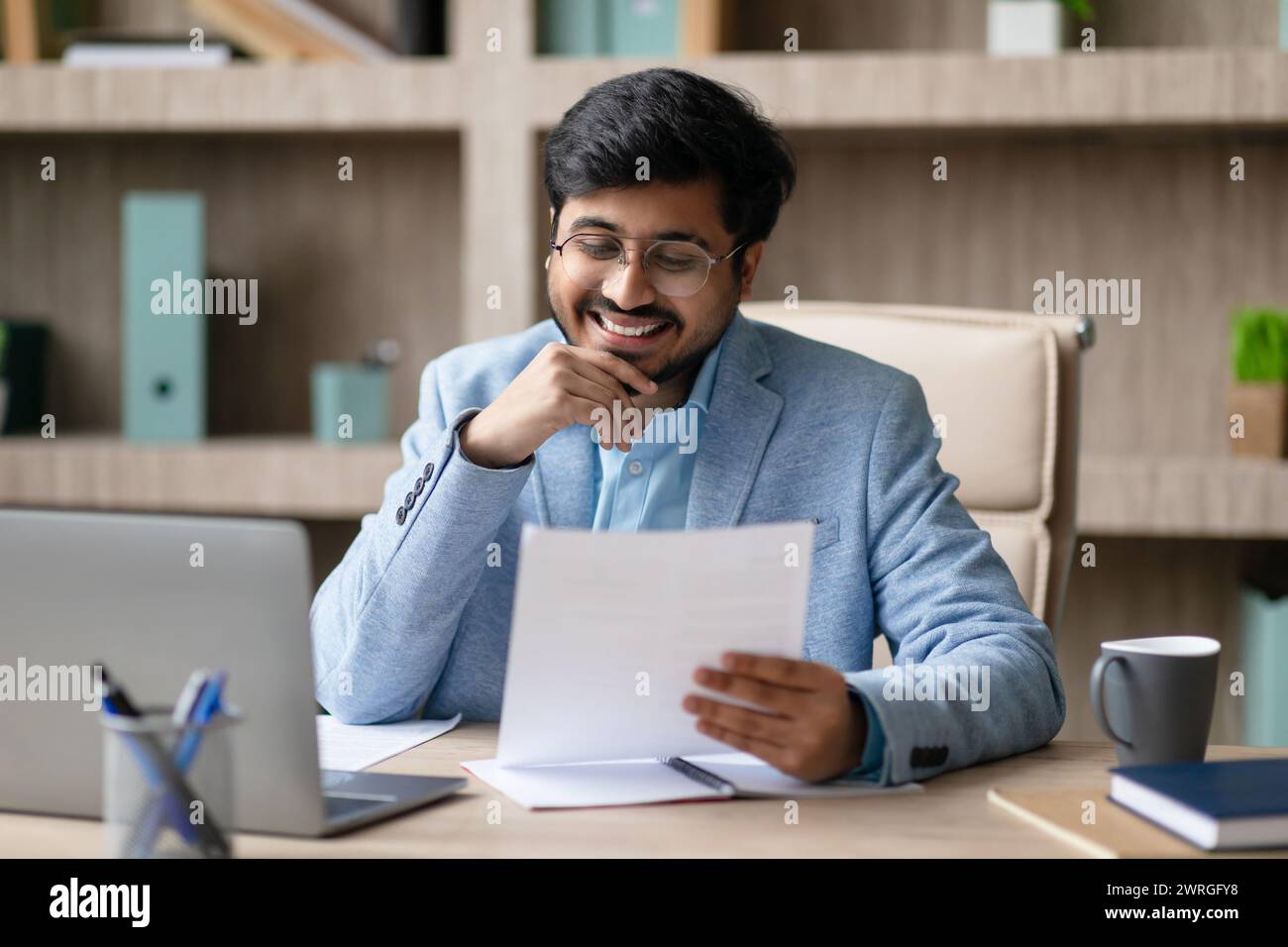 Indian Businessman Engaging In Paperwork Holding And Reading Document ...