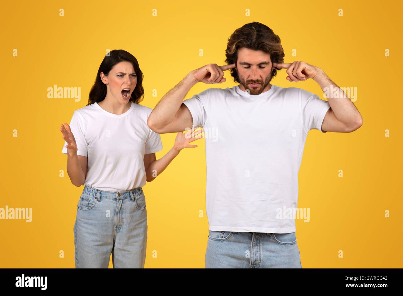 Annoyed woman yelling with hands open in disbelief while man beside her ...