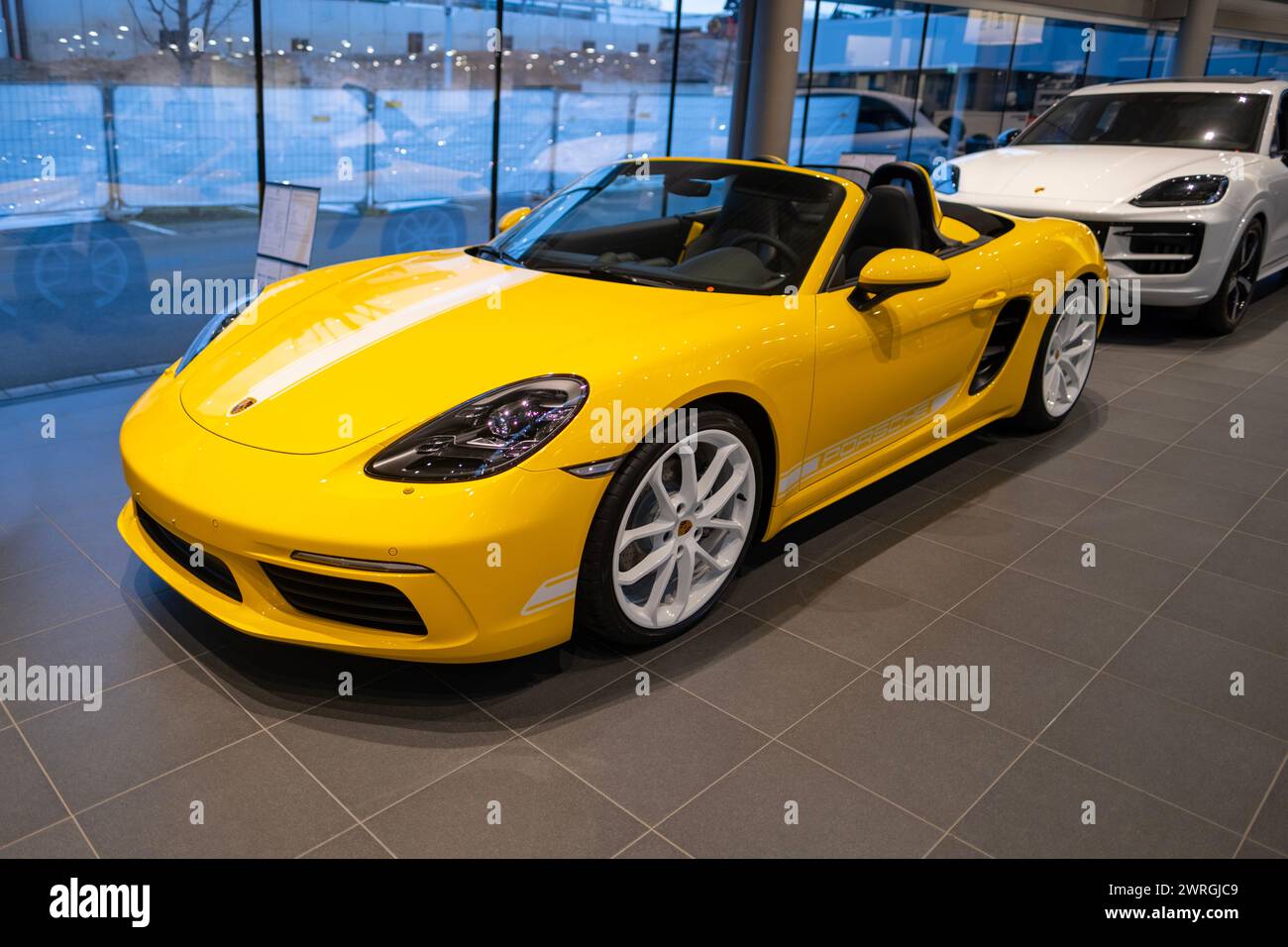 powerful yellow 718 Boxster Spyder RS open-top racing car parked in ...