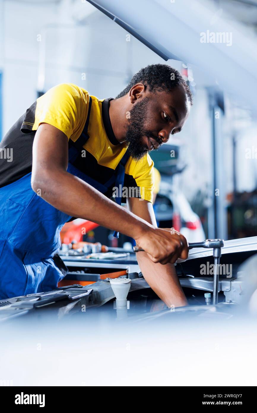 Engineer expertly examines car radiator using advanced mechanical tools ...